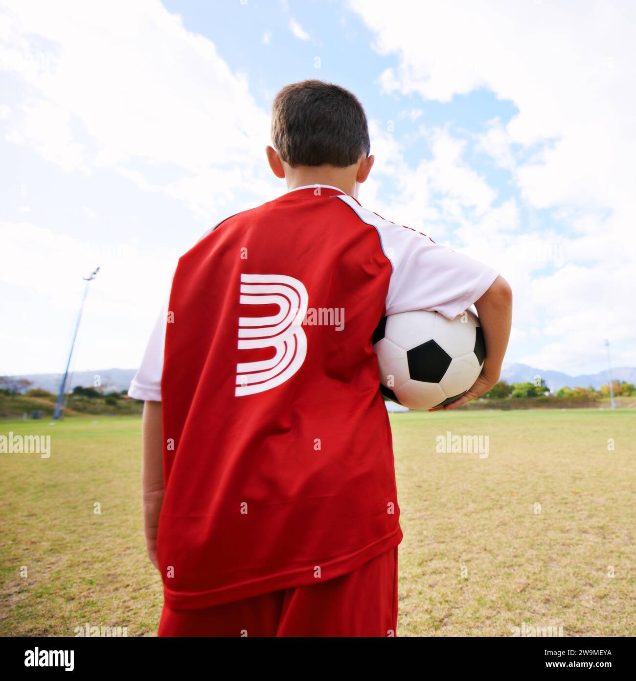 Child, back view and soccer player on field for training, workout and ...