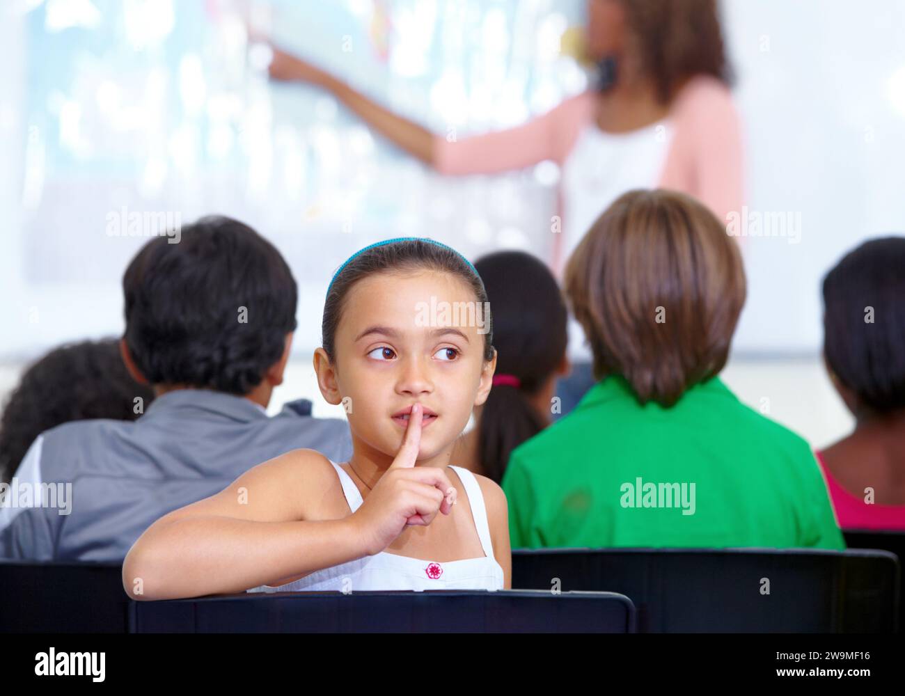Hush sign, secret or child in classroom with mystery, gossip or fingers ...