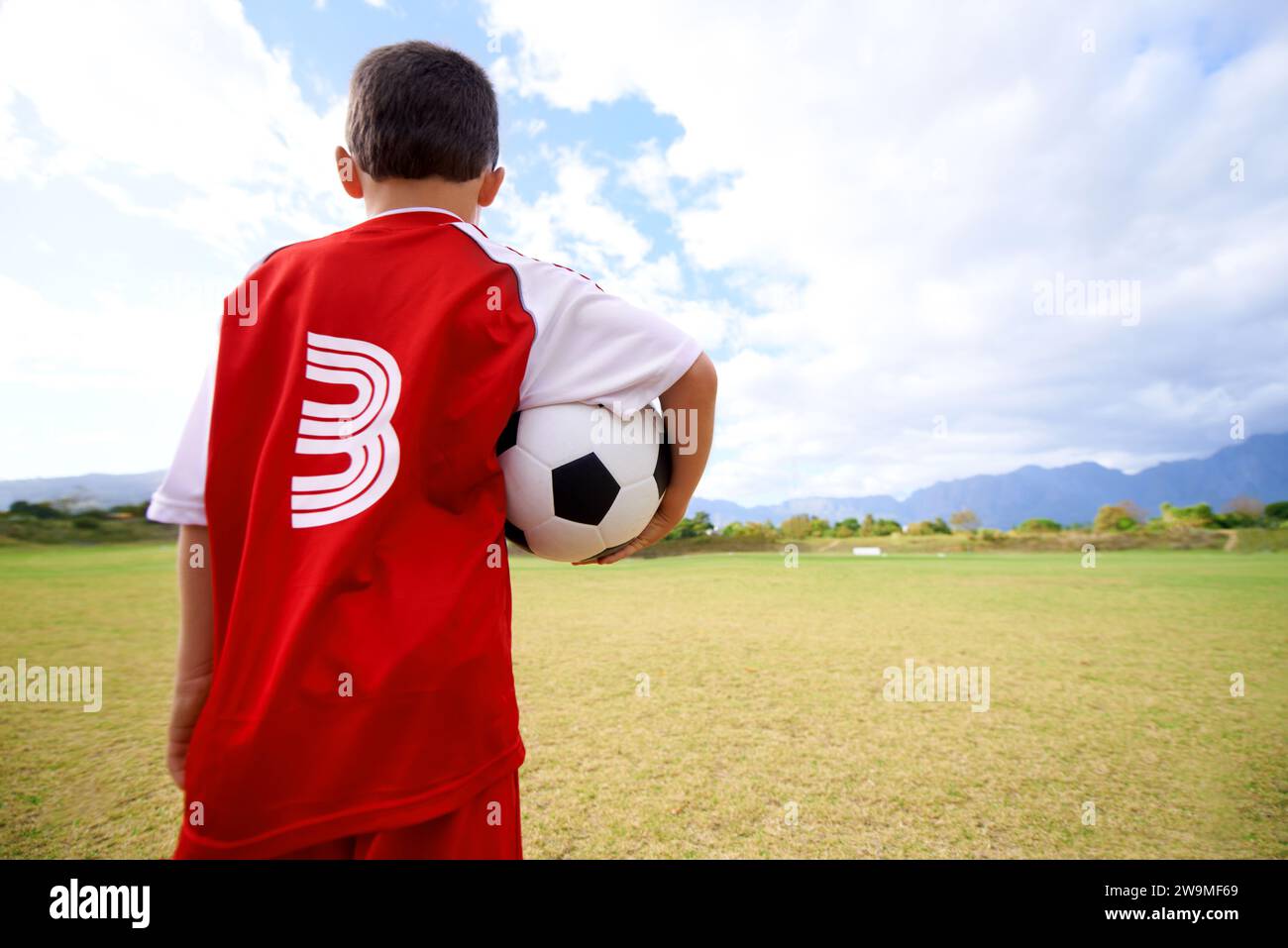 Child, back view and soccer player on field for fitness, workout and ...