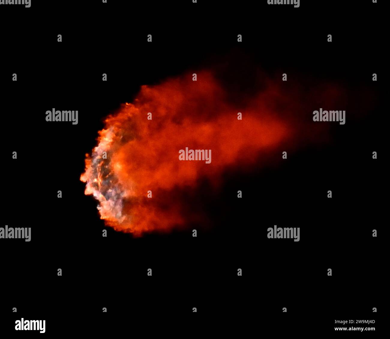 An exhaust plume from a SpaceX Falcon Heavy rocket turns red at ...