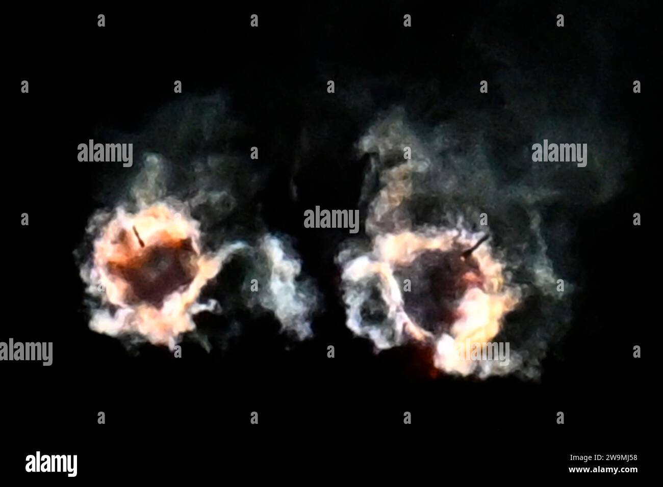 The side boosters of a SpaceX Falcon Heavy rocket can be seen following ...