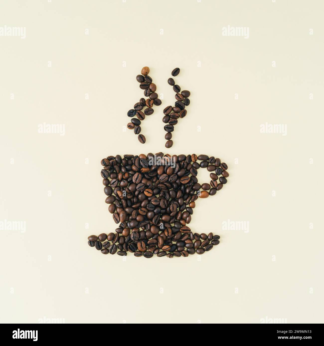 Creative composition with steaming cup of coffee shape made of roasted ...