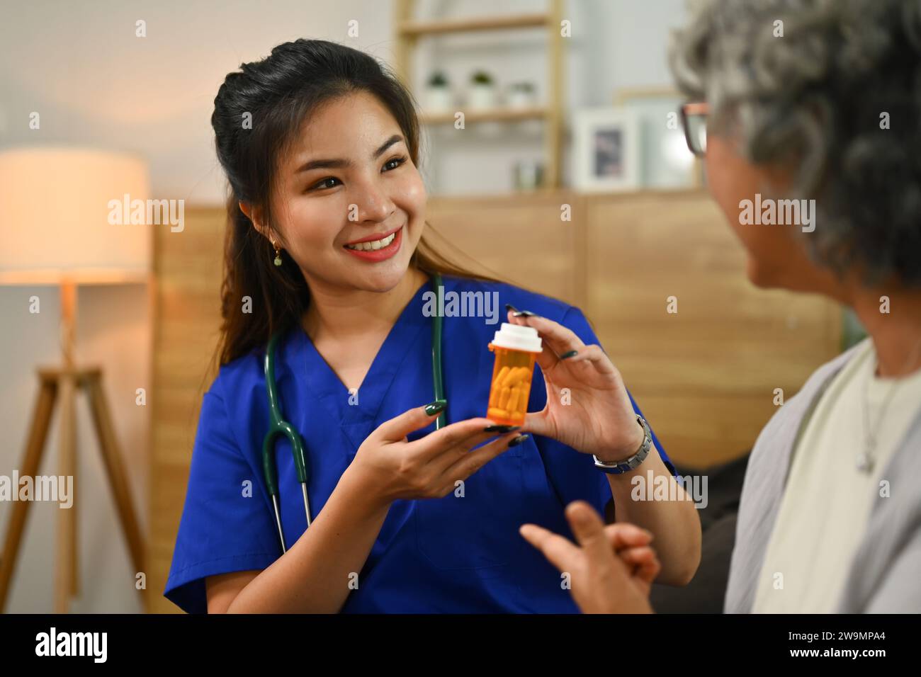 Health visitor explaining medicine dosage to senior patient. Elderly ...