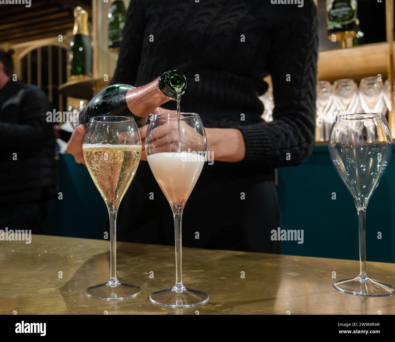 Pouring and tasting of sparkling wine champagne on winter weekend ...