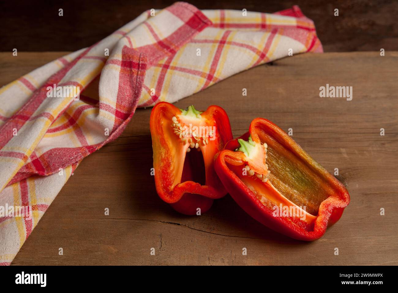 Whole and half red bell pepper (capsicum) known as sweet bell pepper ...