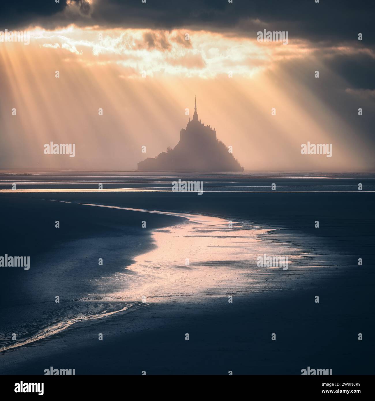Sunlight over silhouette of Mont Saint Michel sanctuary, Normandy ...