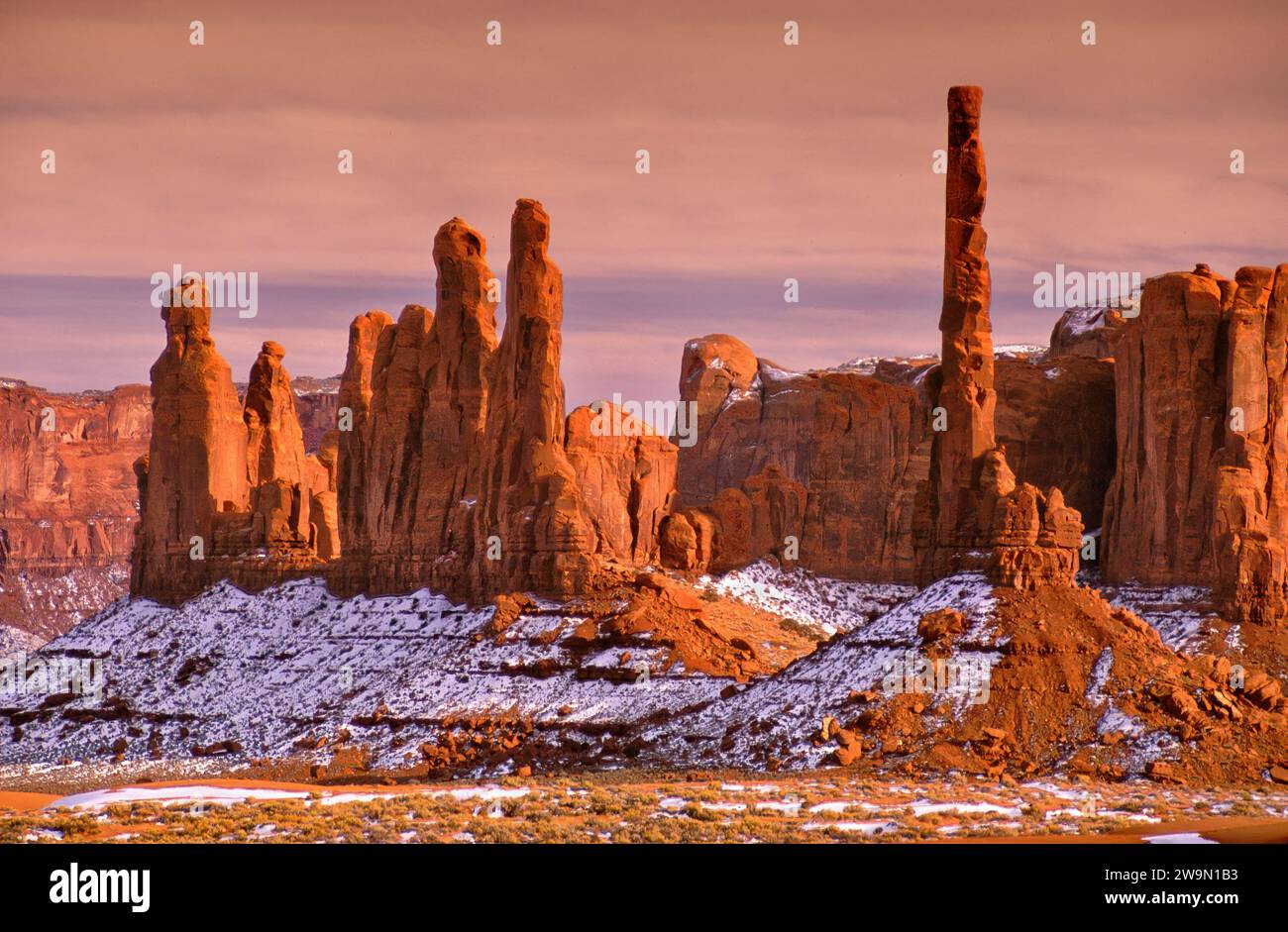 Totem Pole (at right), other rock spires in Monument Valley, at sunset ...