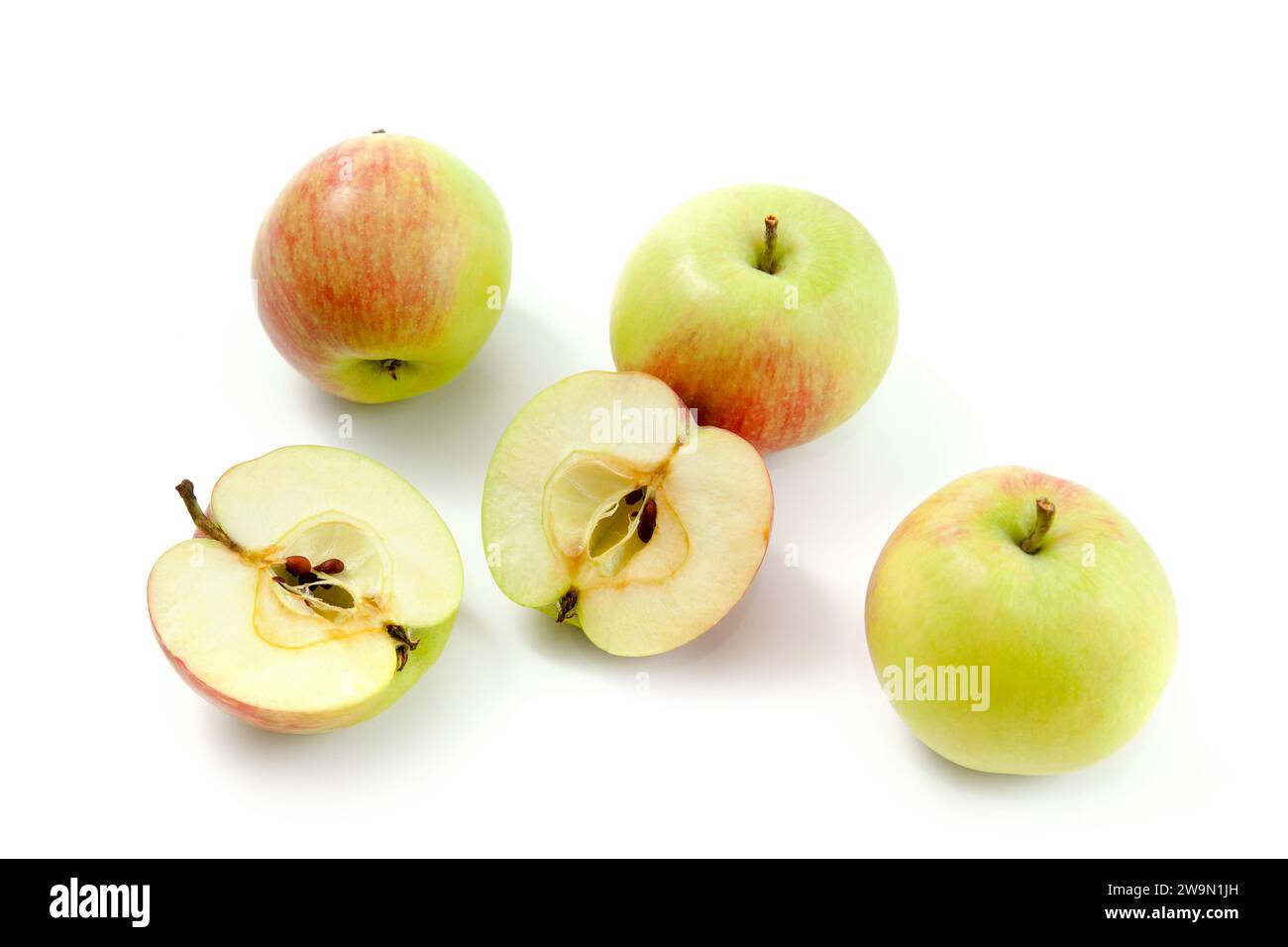 Half and whole of fresh green apples isolated on white background with ...