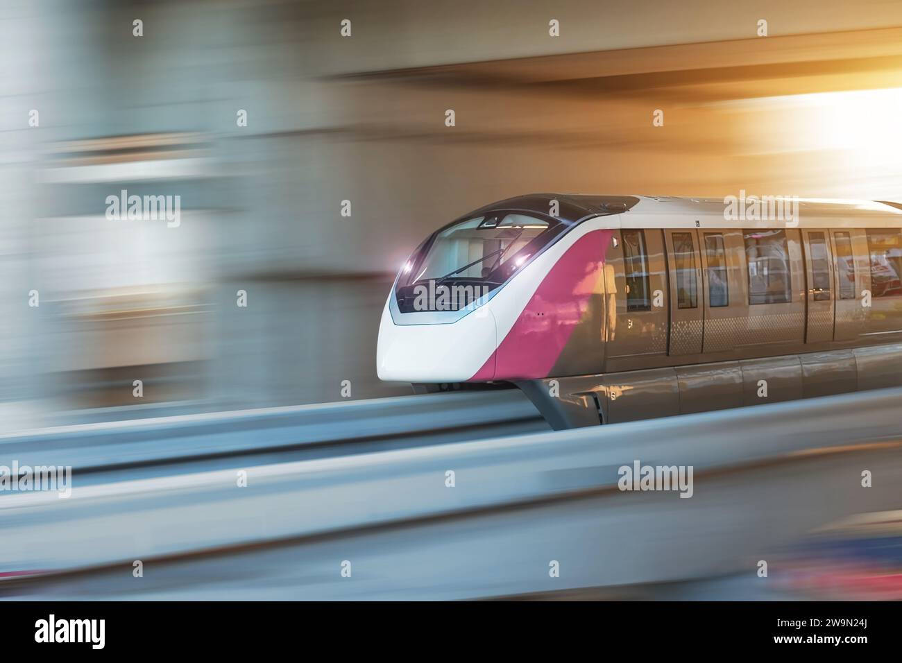 Modern high speed monorail train with bright headlights passes race ...