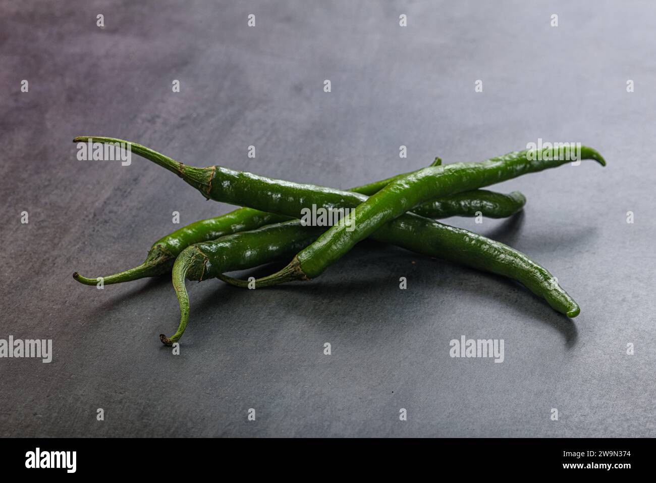 Hot and spicy green chili pepper heap Stock Photo - Alamy