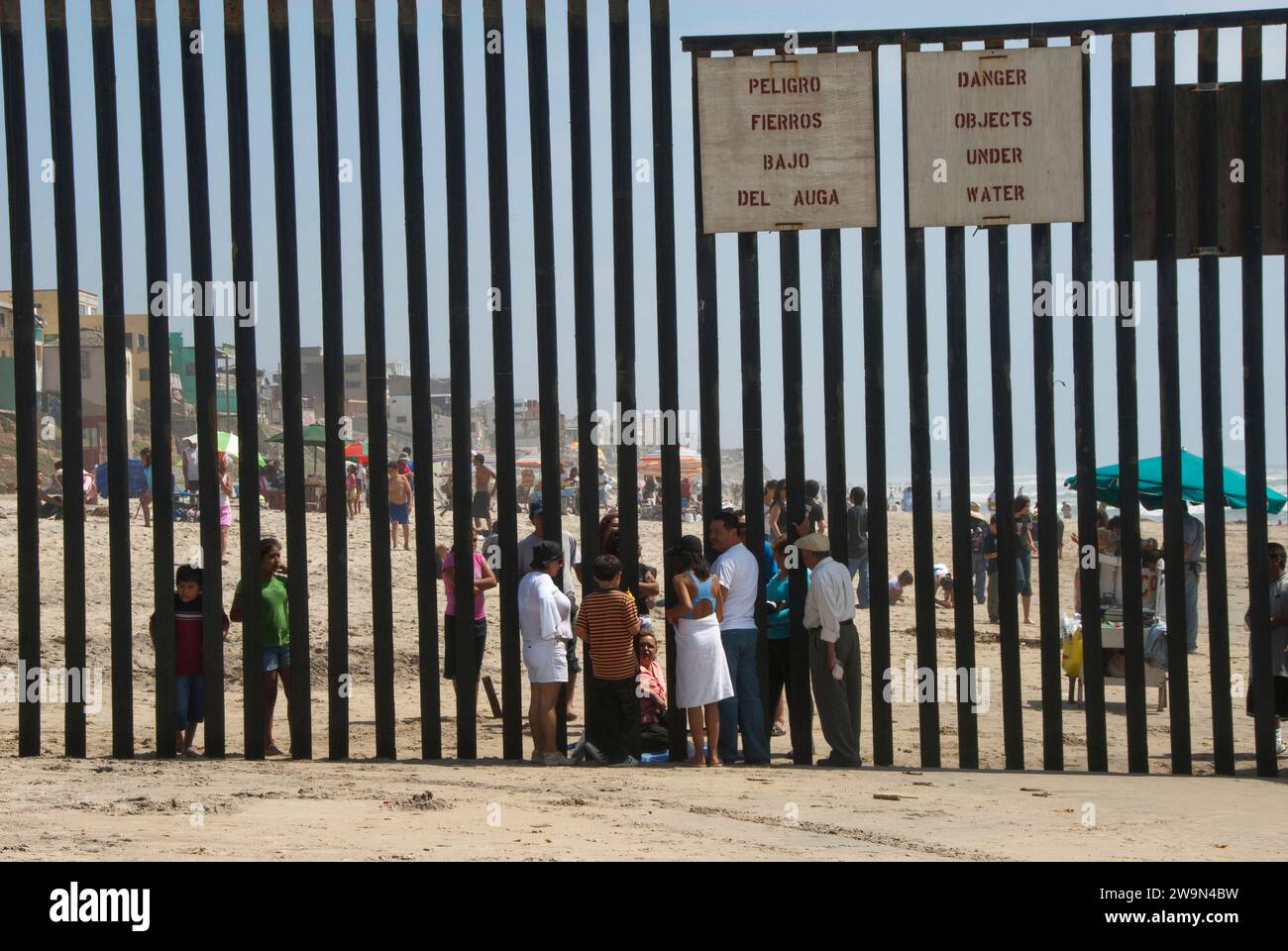 A Mexican family meets at the United States/Mexico border fence at ...