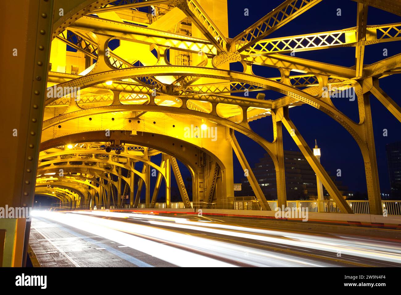 Cars pass under the famous Tower Bridge at night in downtown Sacramento ...