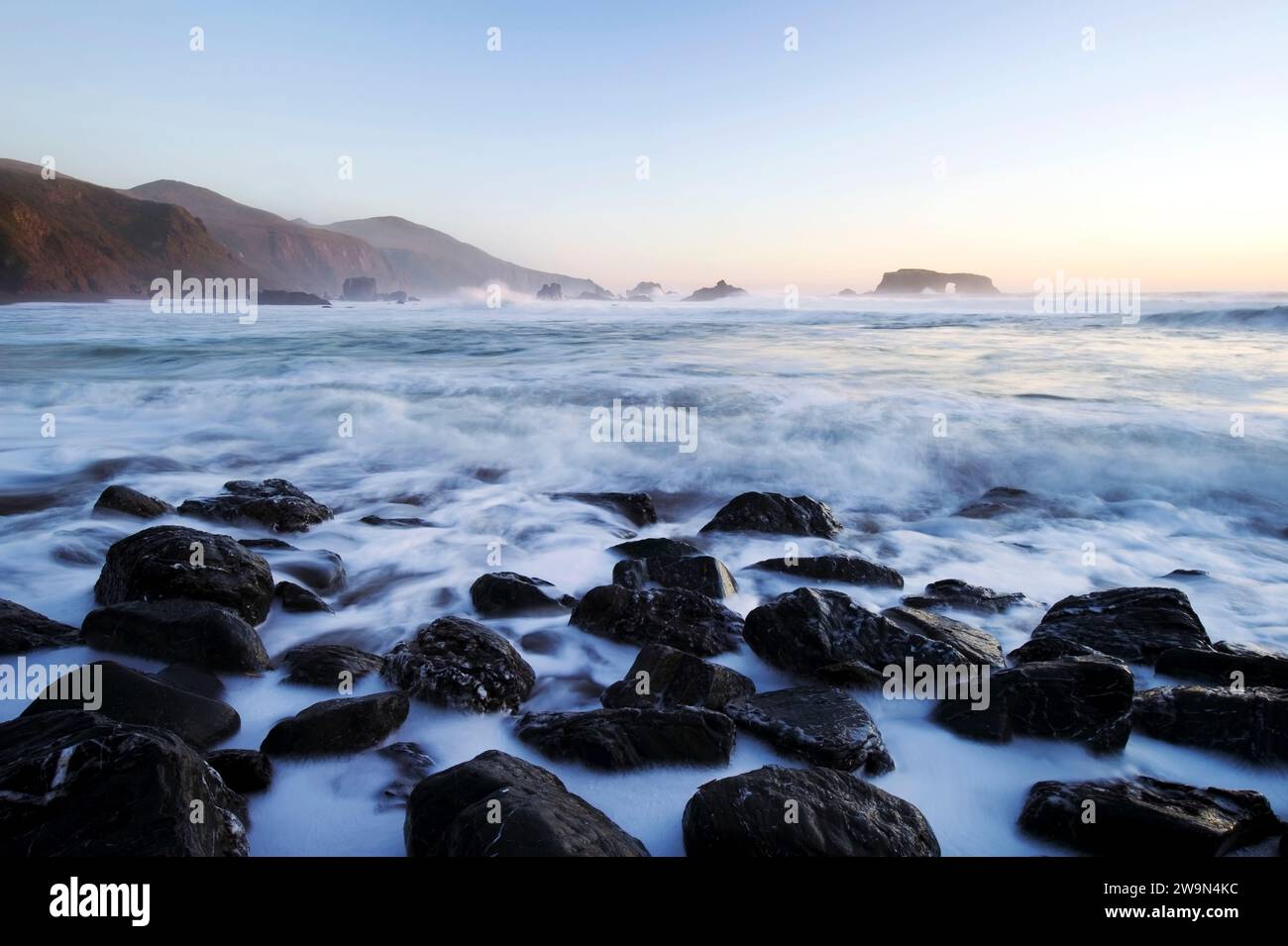 Waves crash to shore at sunset on Blind Beach in Goat Rock State Park ...