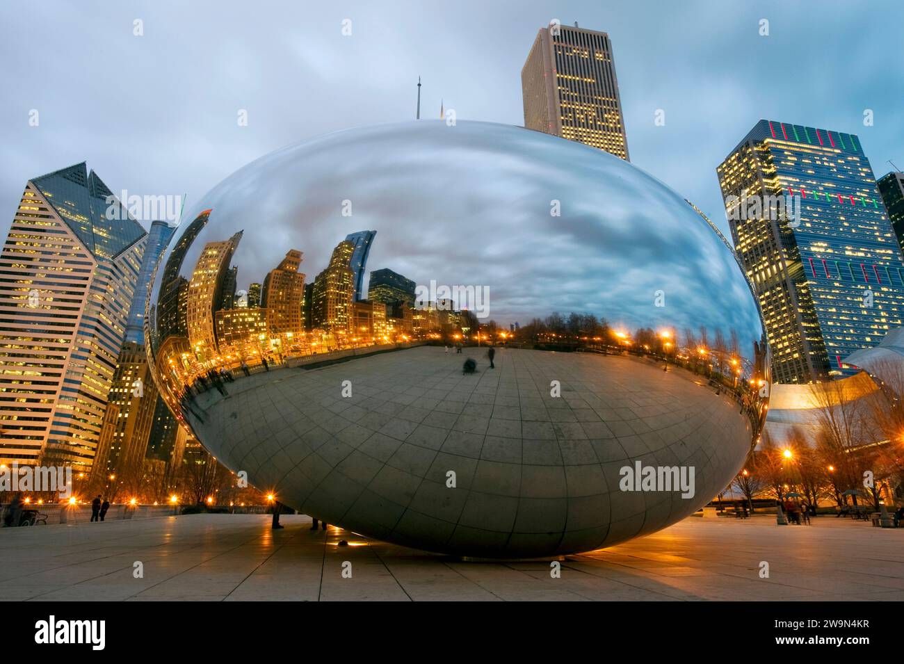 The Chicago skyline is reflected at dusk in the Cloud Gate sculpture ...