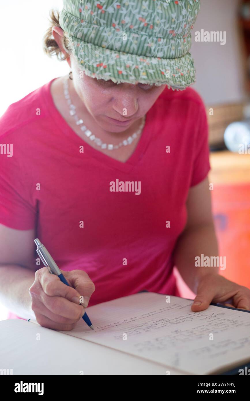 A woman signs the guest book at a traditional Rastafarian home at the ...