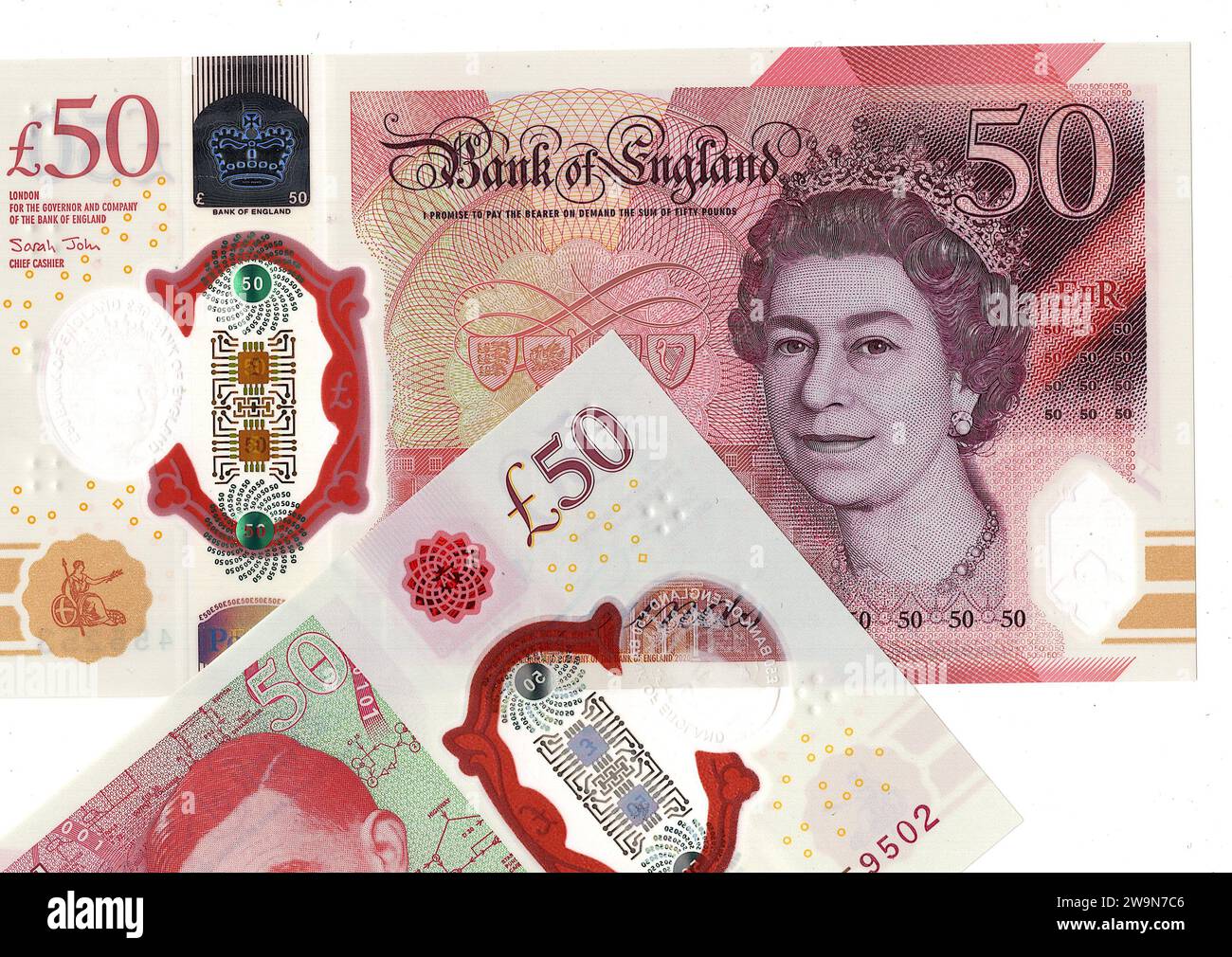 Close up of fifty pound notes from the United Kingdom on a white ...