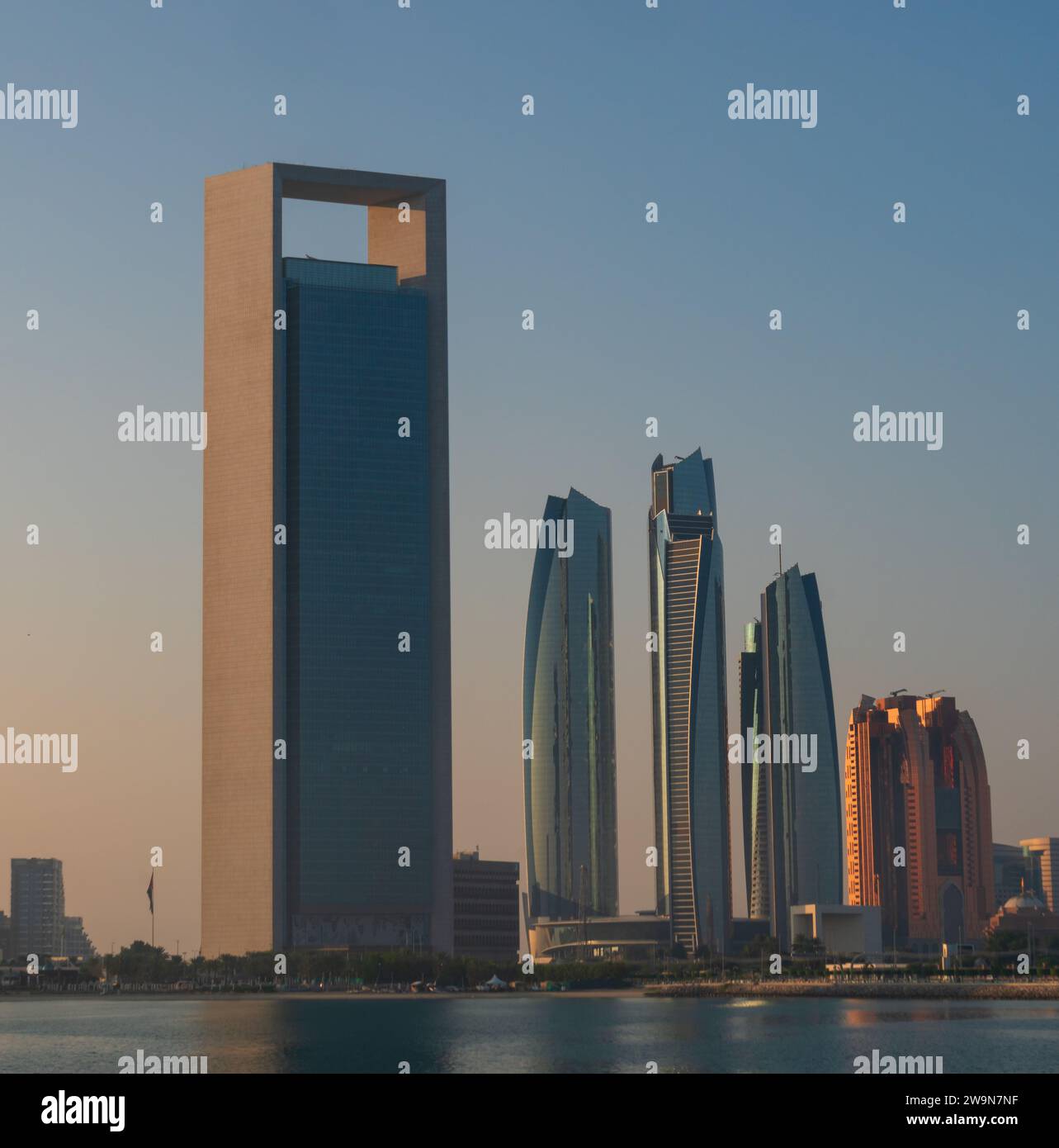 The Etihad towers in Abu Dhabi at sunrise, clear sky and water ...