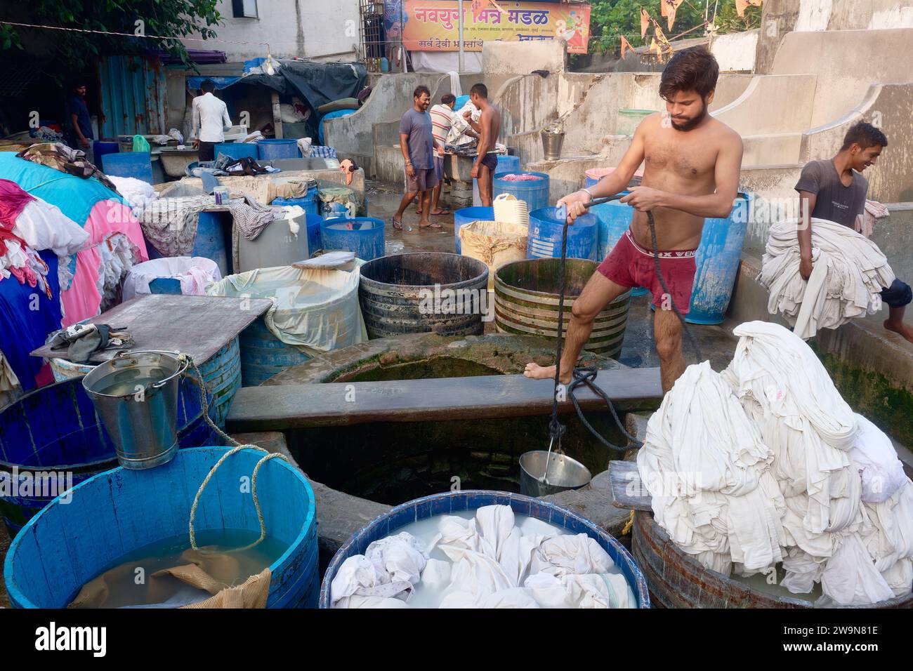 A dhobi (washerman) at Walkeshwar Dhobi Ghat, a traditional open-air ...