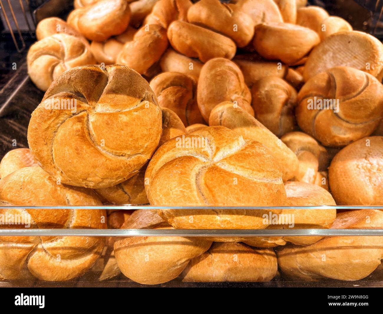 Loaves of Italian bread called rosetta in window self-service dispenser ...