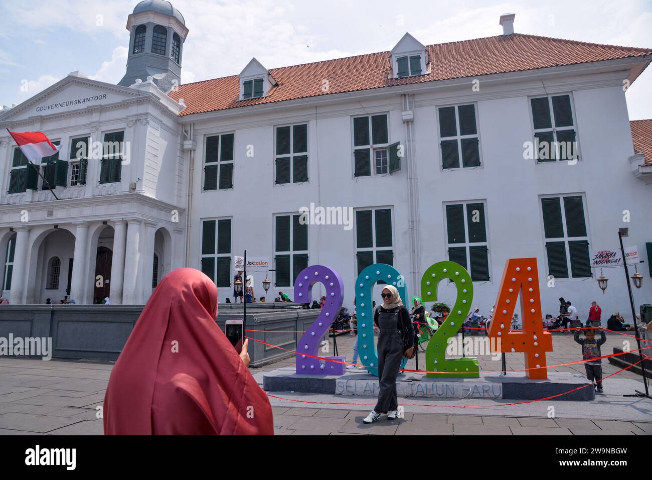 Jakarta, Indonesia. 29th Dec, 2023. People take photos with a "2024 ...
