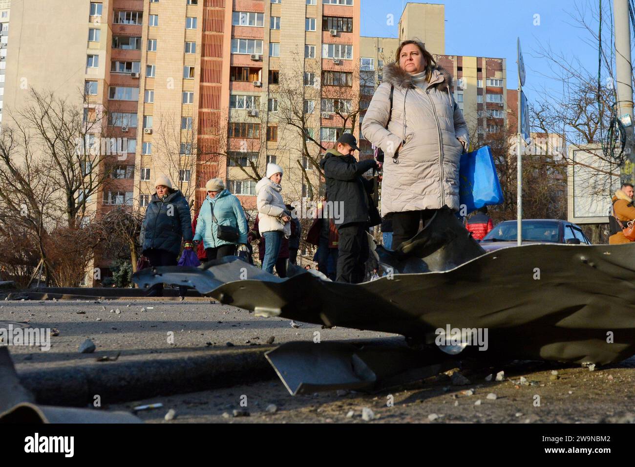 Kyiv, Ukraine. 29th Dec, 2023. People walk past the debris lying in the ...