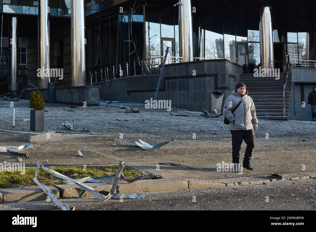 Kyiv, Ukraine. 29th Dec, 2023. People walk past the debris lying in the ...