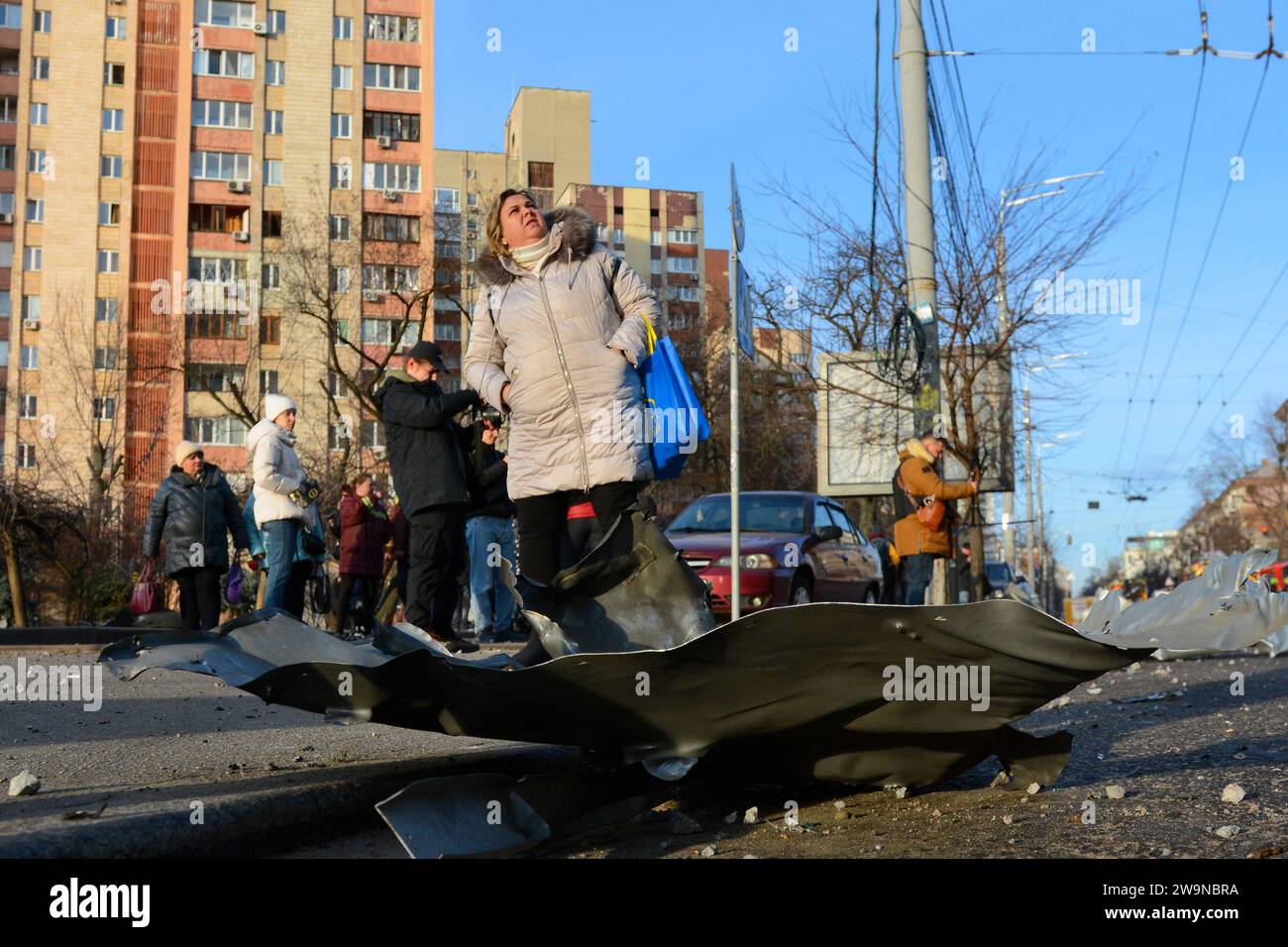 Kyiv, Ukraine. 29th Dec, 2023. People walk past the debris lying in the ...