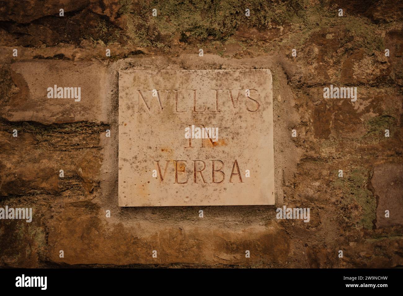Old plaster brick wall texture with sign board with vintage latin text ...