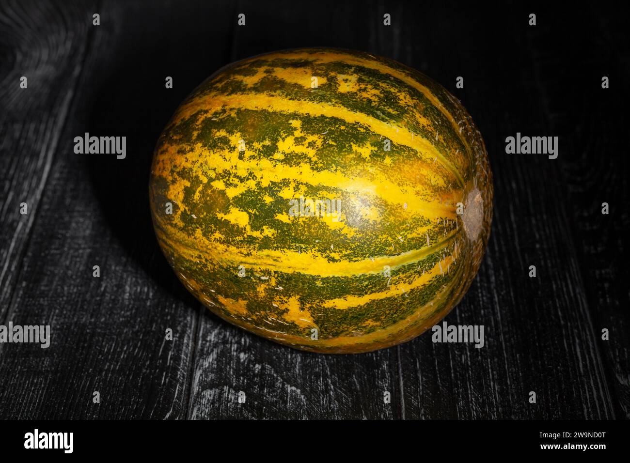 one melon on wood background Stock Photo - Alamy