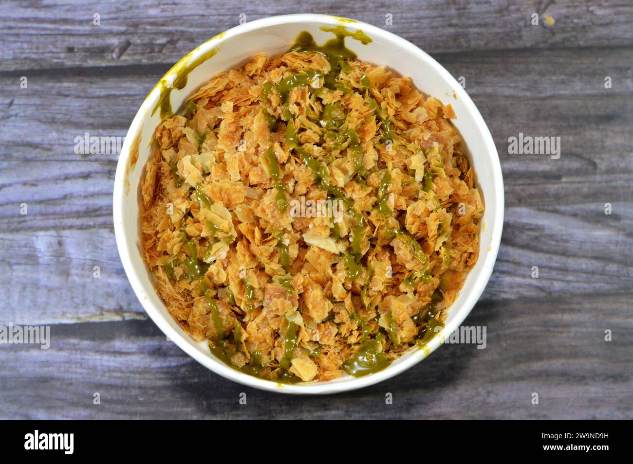 Pistachio sauce on top of Sweet Koshary recipe in Egypt made of multi ...