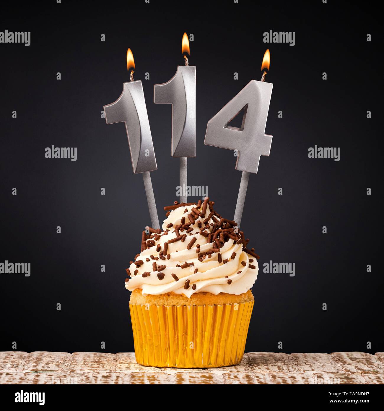 birthday cupcake with number 114 candle - Celebration on dark ...