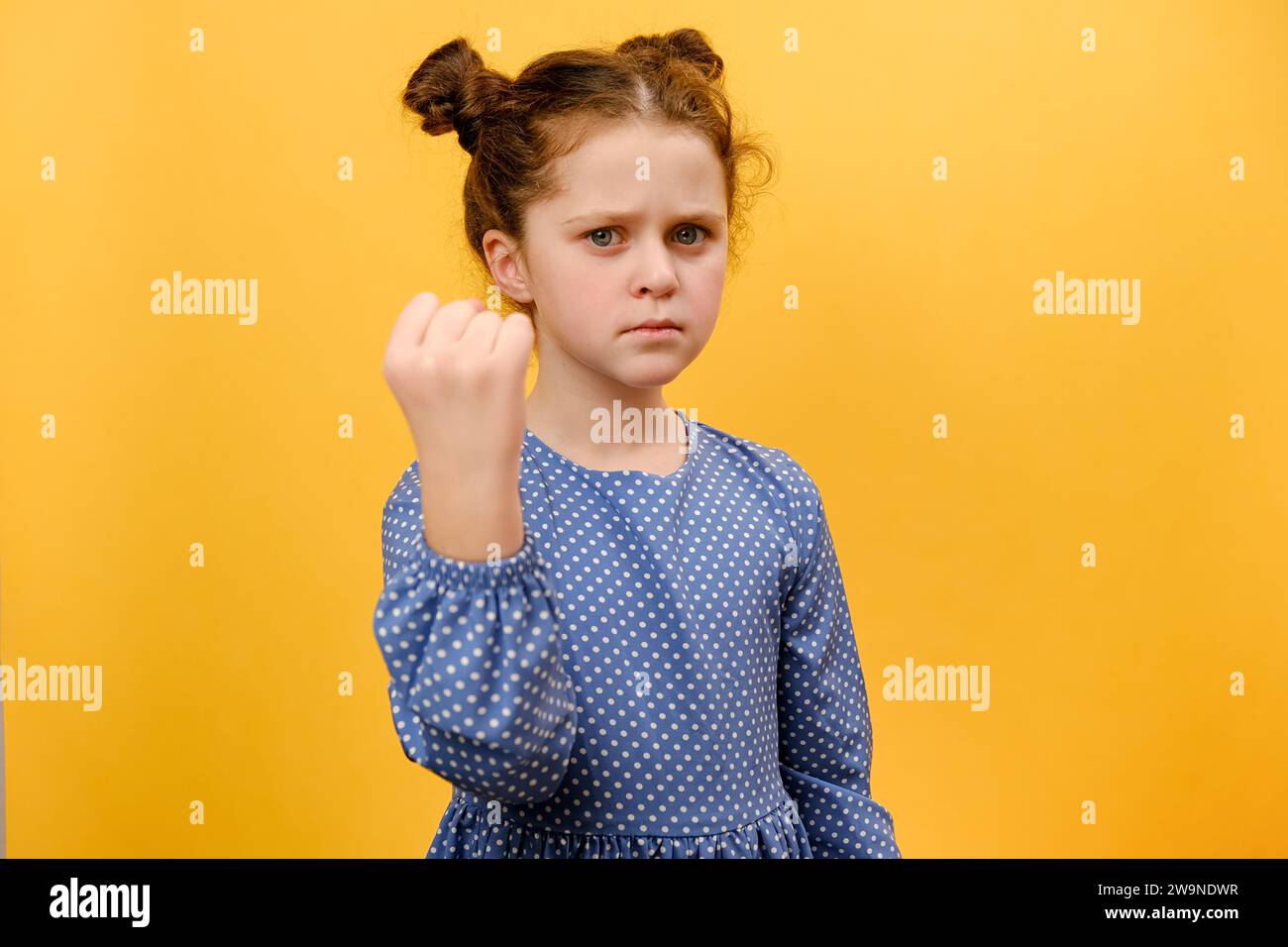 Portrait of aggressive angry little girl kid trying to fight at camera ...