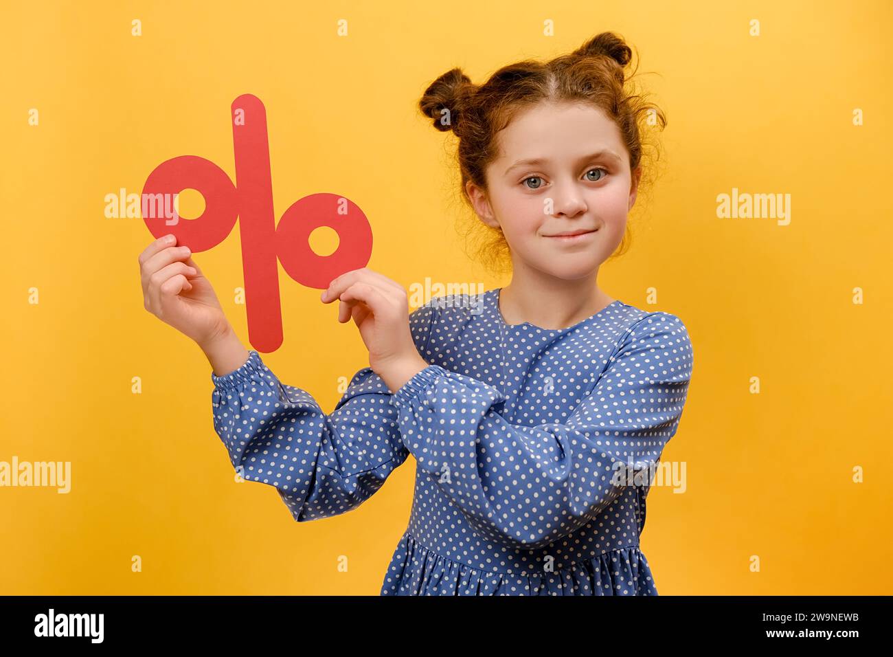 Portrait of pleasant happy preteen girl child holding red percent mark ...