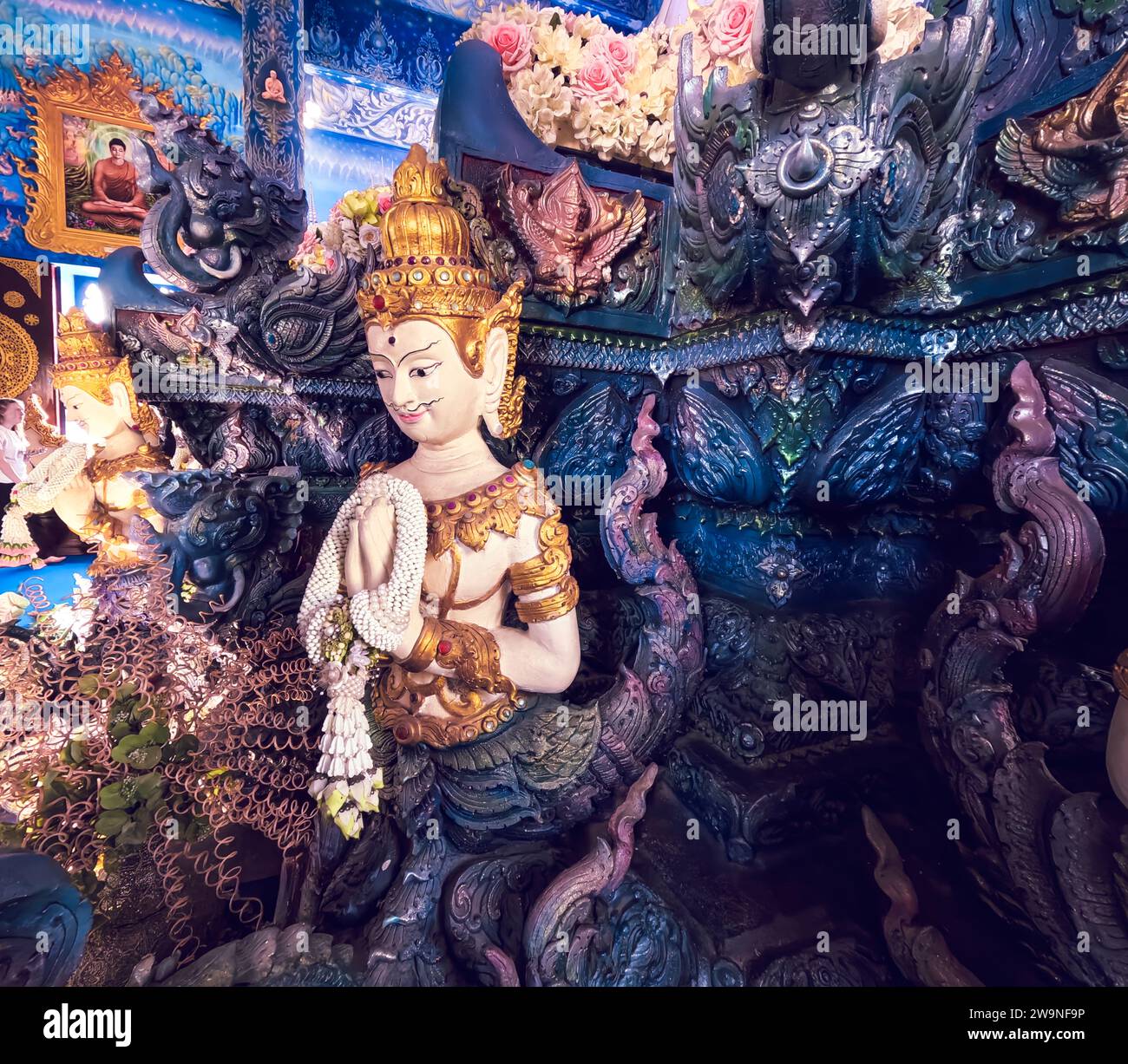 Hand-carved wood idol mythical inside Wat Rong Suea Ten Blue Temple at ...