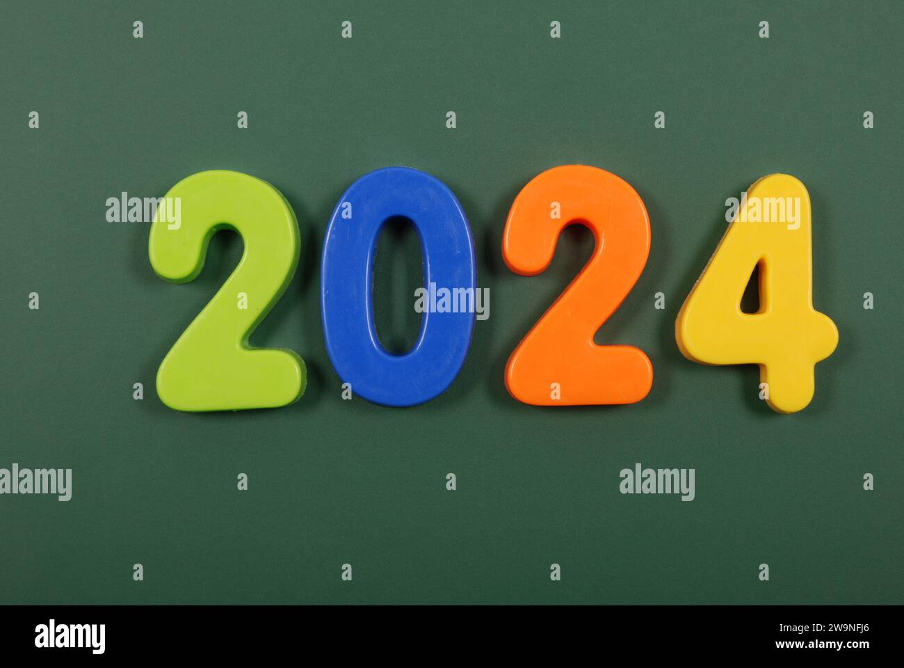 2024 year written in bright plastic magnetic letters stuck on a ...
