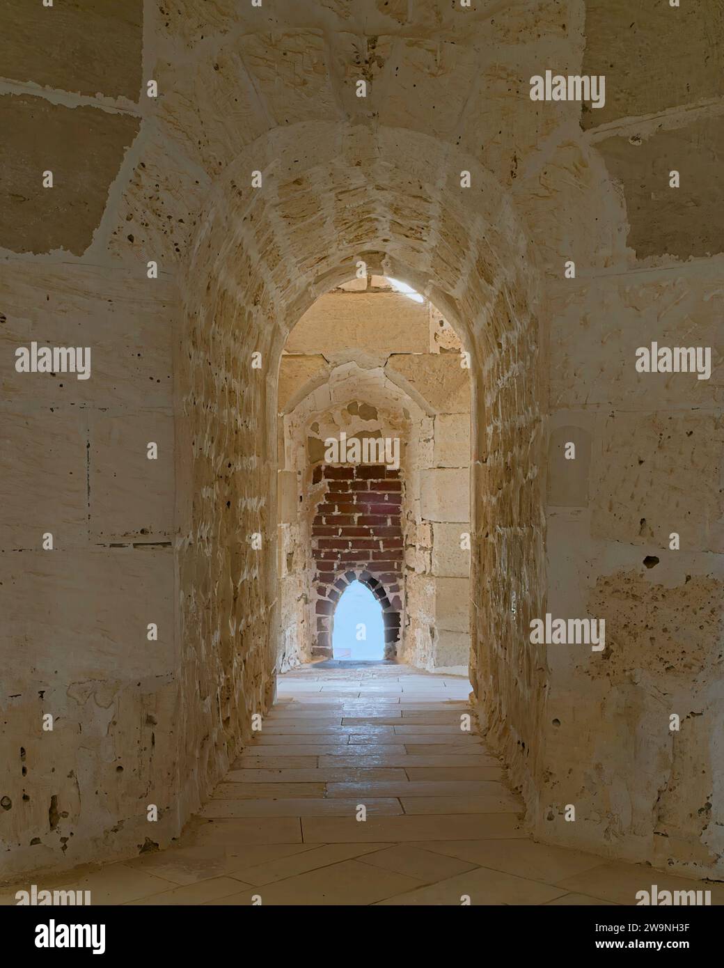 Weathered intricate stone archway leading into a mysterious brick ...