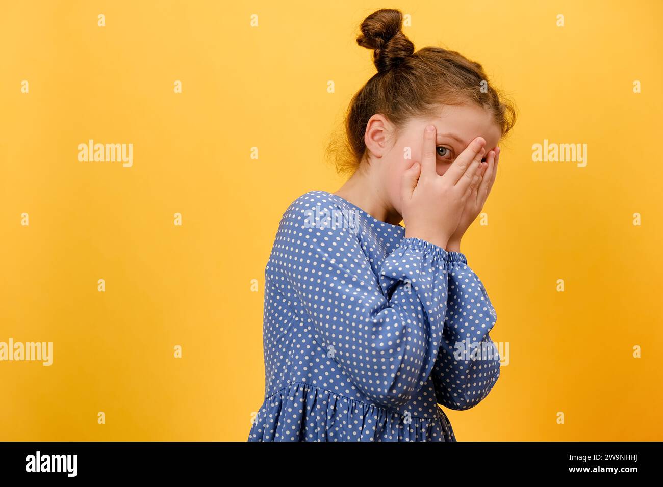 Portrait of shocked little girl kid covers face with hands, posing ...
