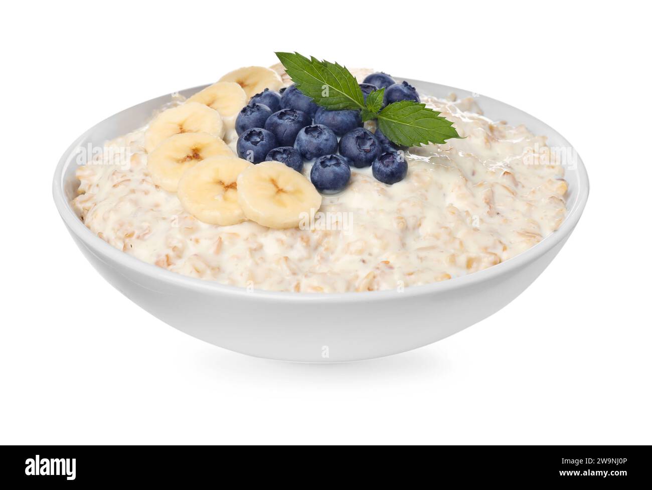 Tasty boiled oatmeal with banana and blueberries in bowl isolated on ...