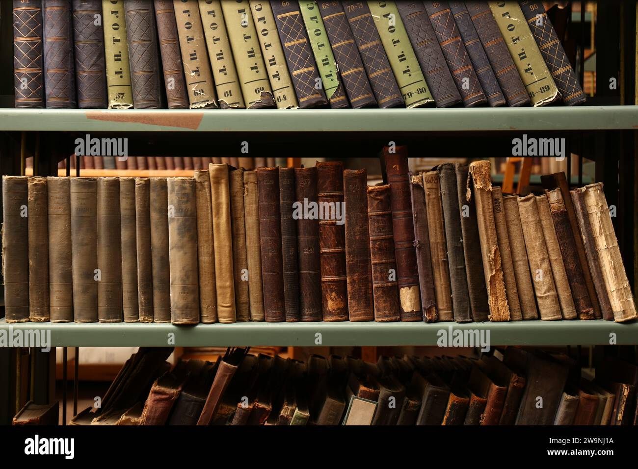 Collection of old books on shelves in library Stock Photo - Alamy