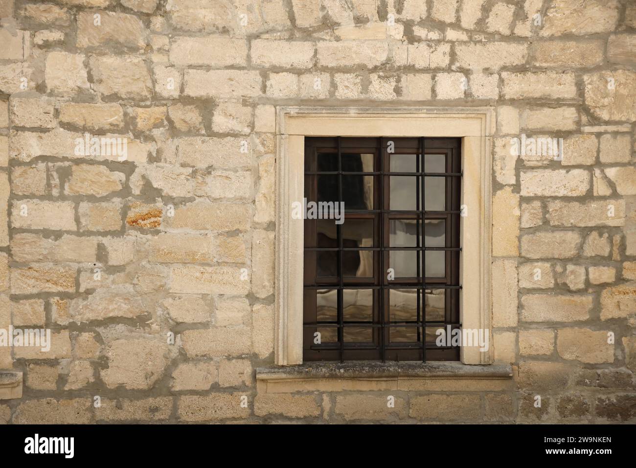 Very old window in brick stone wall of castle or fortress of 18th ...