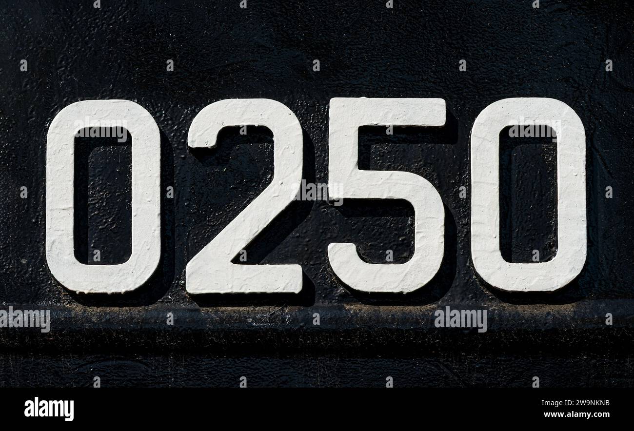 Weathered numbers zero, two, five, 0250, or 0, 2, 5 painted white on a ...
