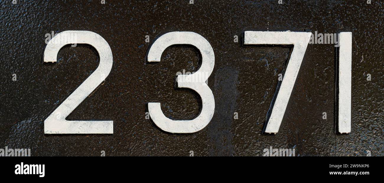 Weathered numbers two, three, seven, one, 2371 or 2, 3, 7, 1 painted ...
