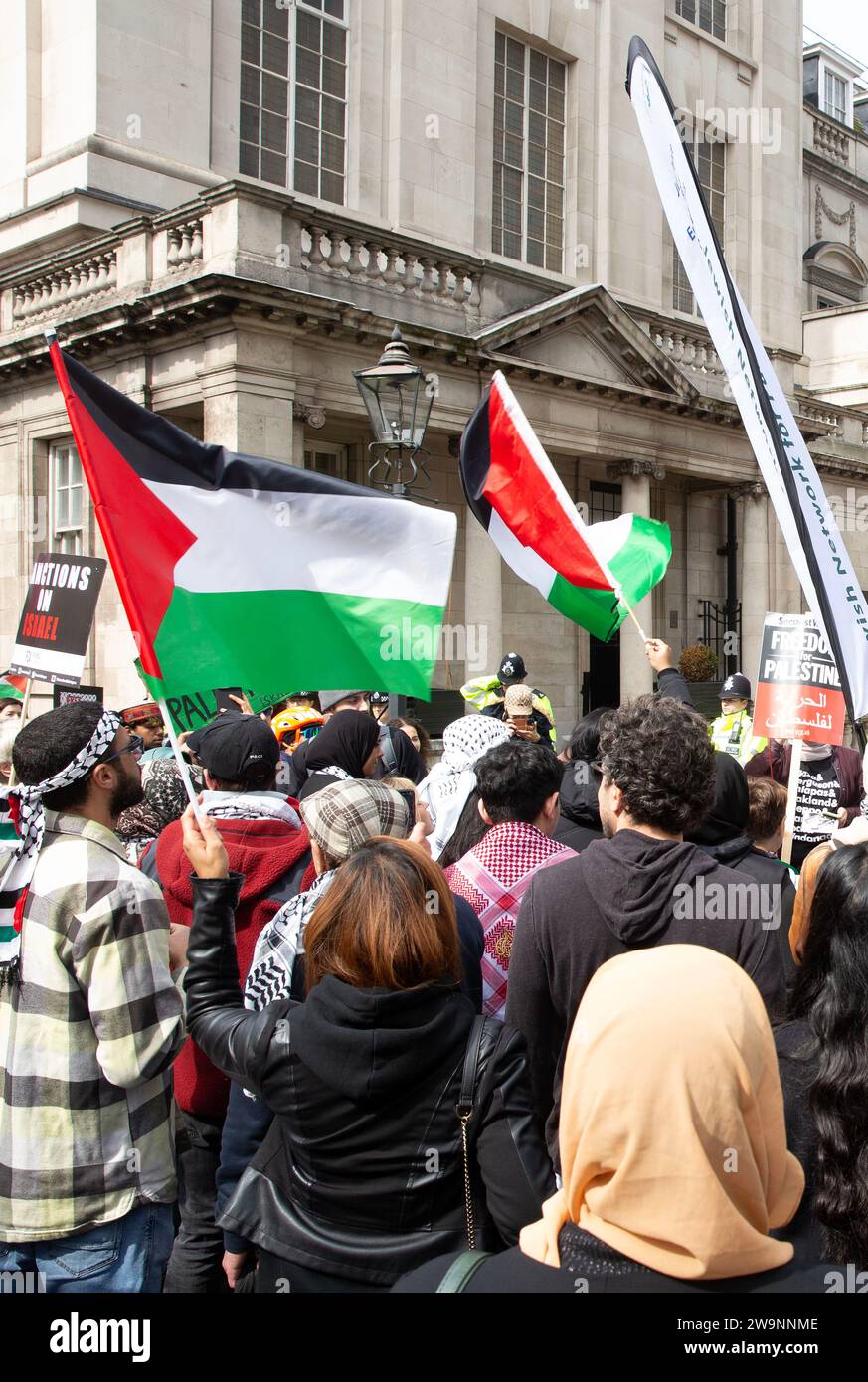 Pro-Palestinian protesters gather with flags and placards during a ...