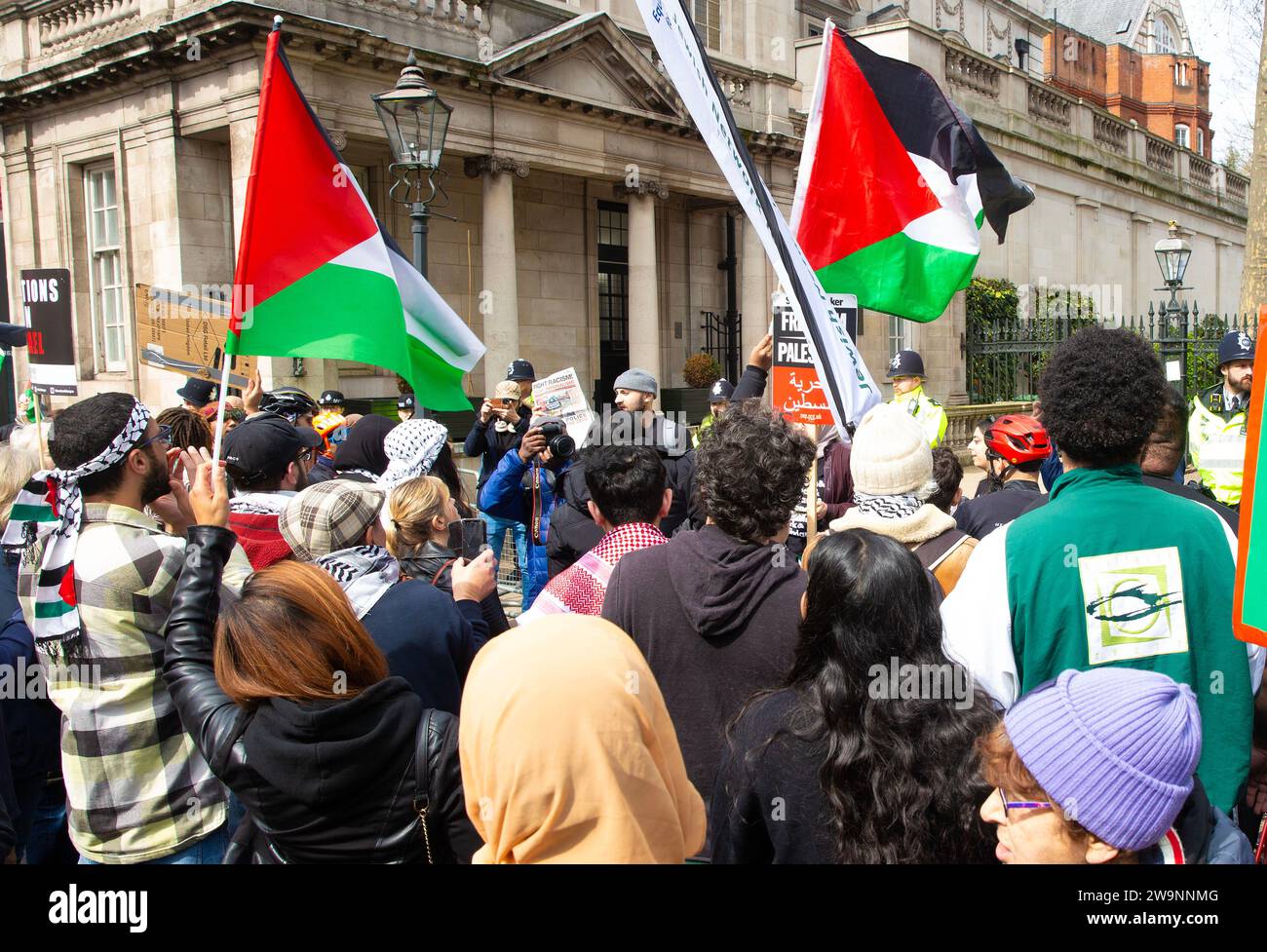 Pro-Palestinian protesters gather with flags and placards during a ...