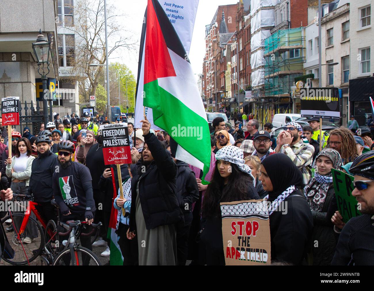 Pro-Palestinian protesters gather with flags and placards during a ...