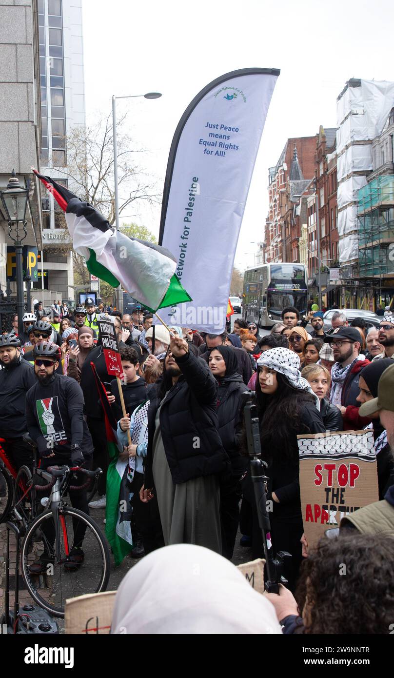 Pro-Palestinian protesters gather with flags and placards during a ...
