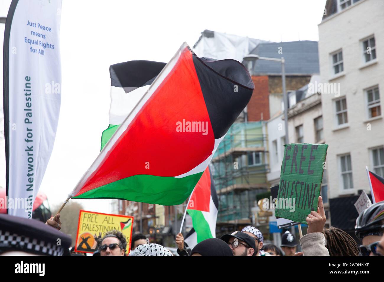 Pro-Palestinian protesters gather with flags and placards during a ...