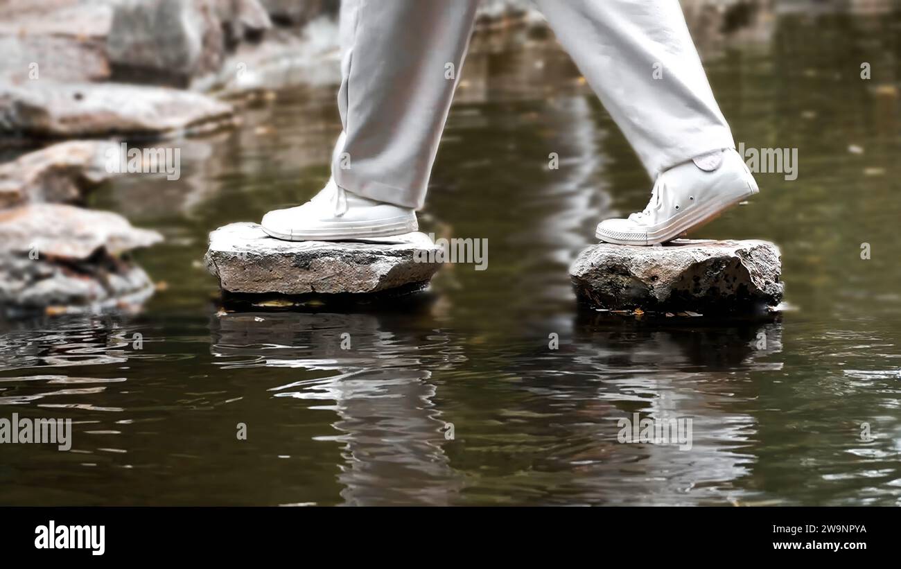 Young woman crossing river rope hi-res stock photography and images - Alamy