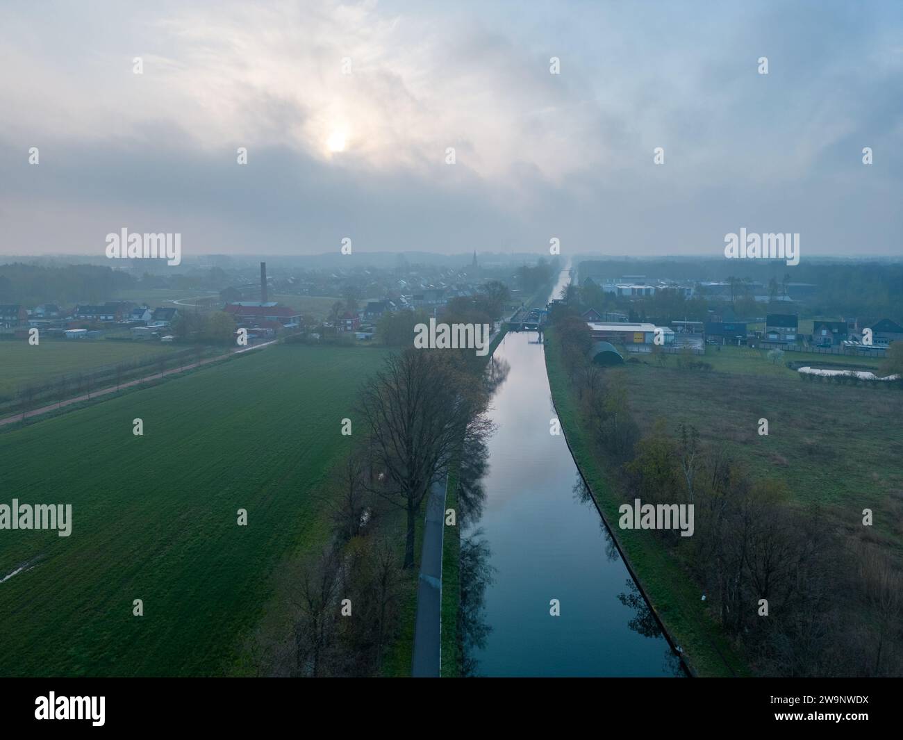 An early morning aerial photograph depicts a serene canal cutting ...