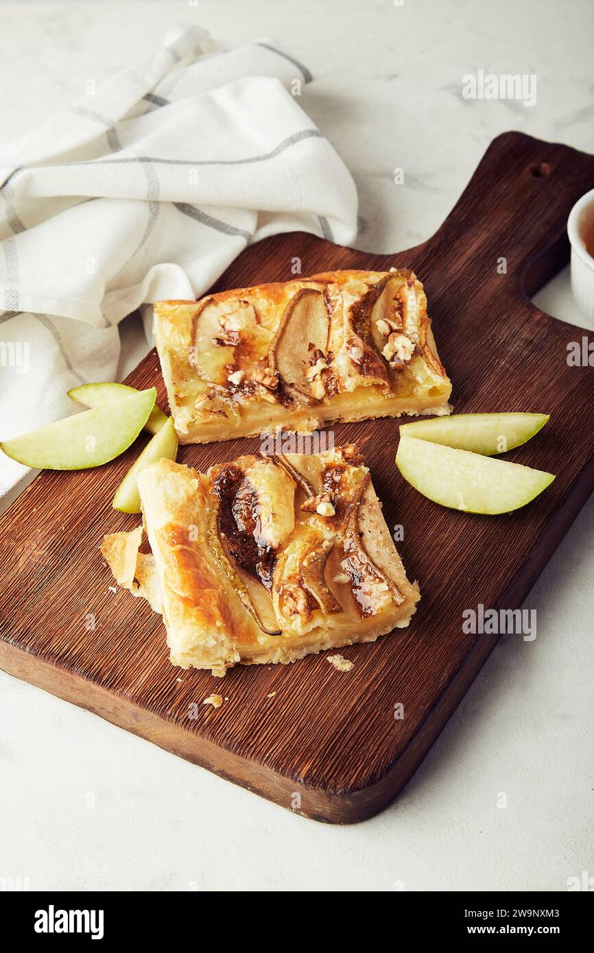 Mini tarts with puff pastry, pieces of pear, camembert, walnuts and ...